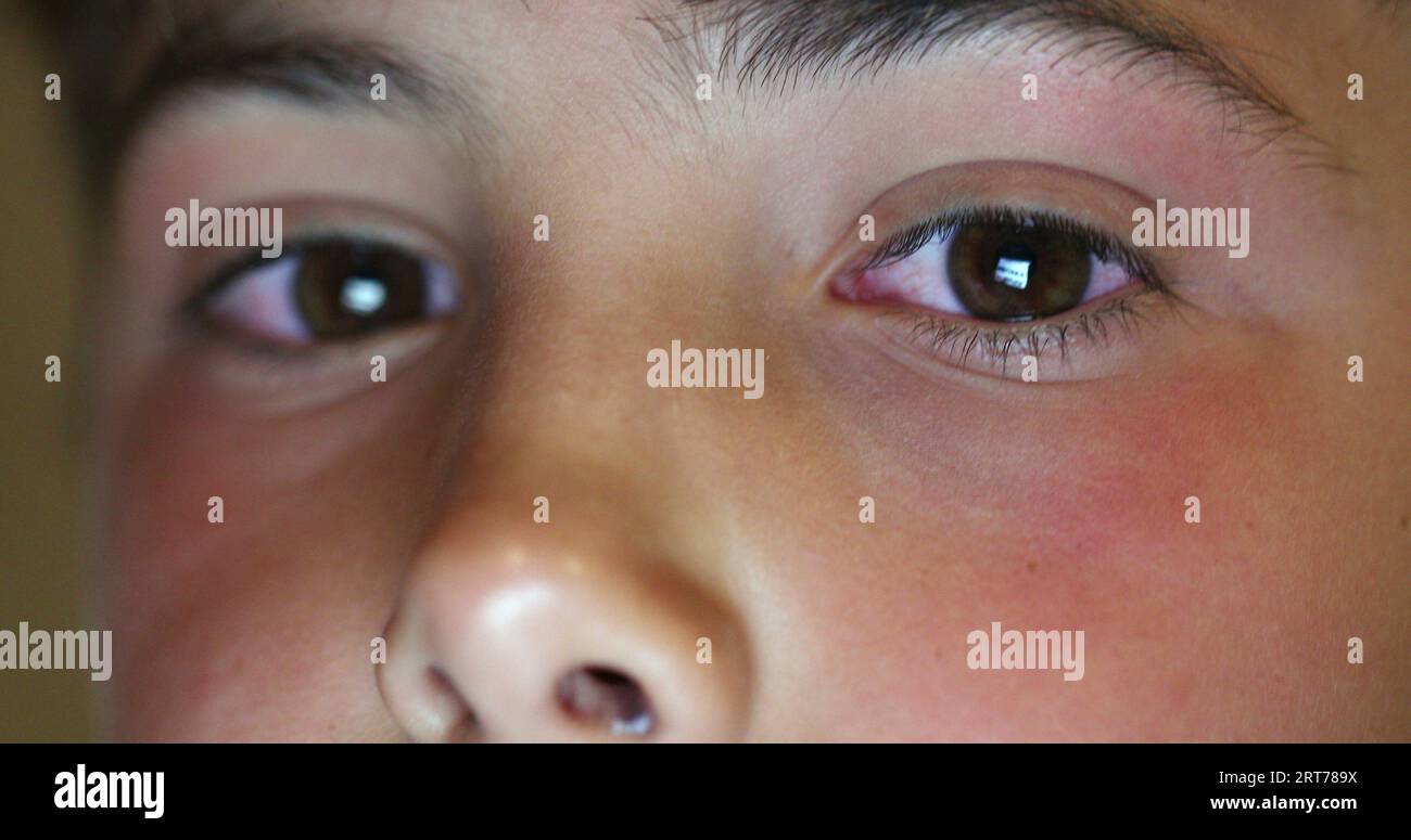 Boy eyes staring at screen at night. Child macro close-up eye watching ...