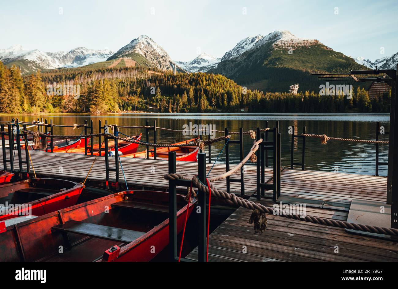 Red boats in port bounded in wooden mole on Strbske pleso lake in High ...