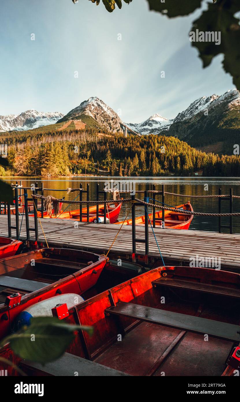 Red boats in port bounded in wooden mole on Strbske pleso lake in High ...
