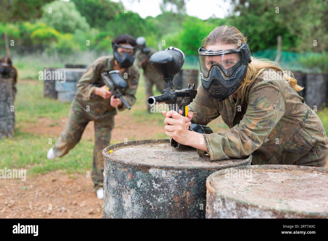 Team of friends paintball players playing together in battle Stock ...