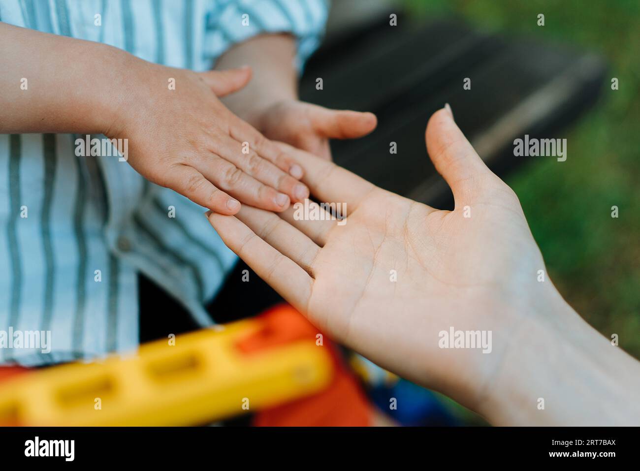 Mother and child are touching palms, expressing love Stock Photo - Alamy