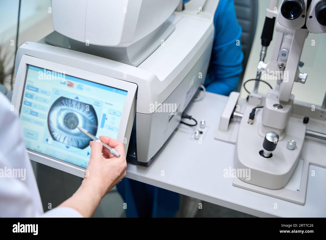 Vision specialist taking automated objective refraction measurement in ...