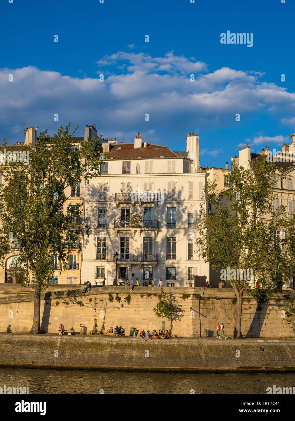 Evening Light, Apartments and people relaxing on the River Bank, River Seine, Île Saint-Louis ...