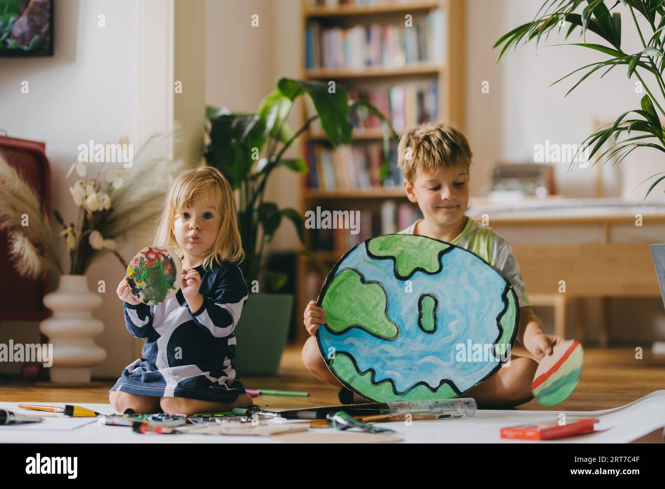 Siblings painting at home with watercolors and tempera paints, creating ...