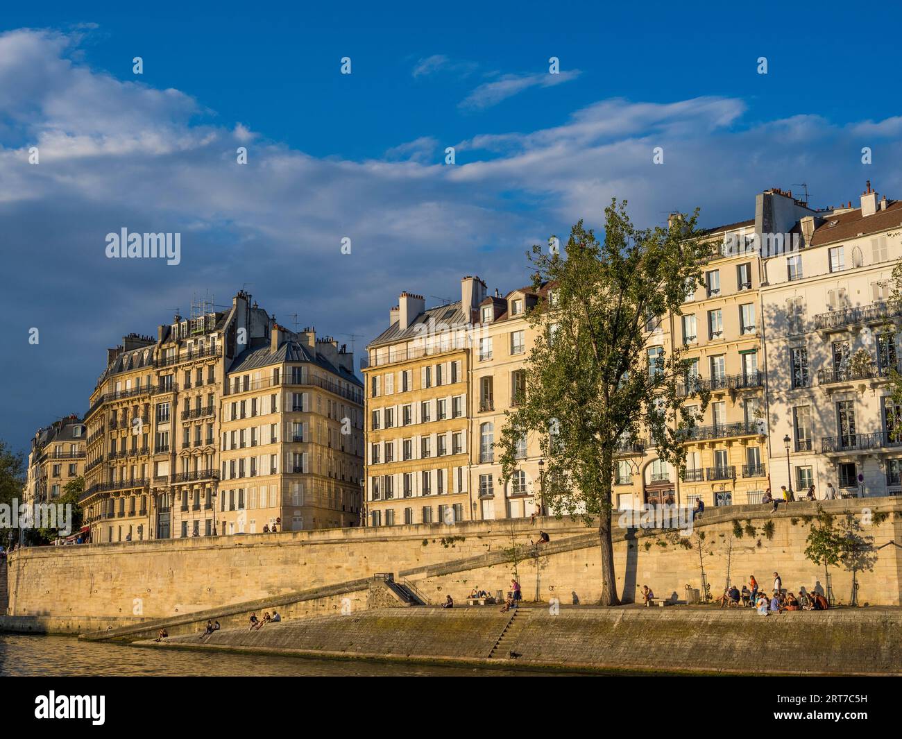 Evening Light, Apartments and people relaxing on the River Bank, River Seine, Île Saint-Louis ...