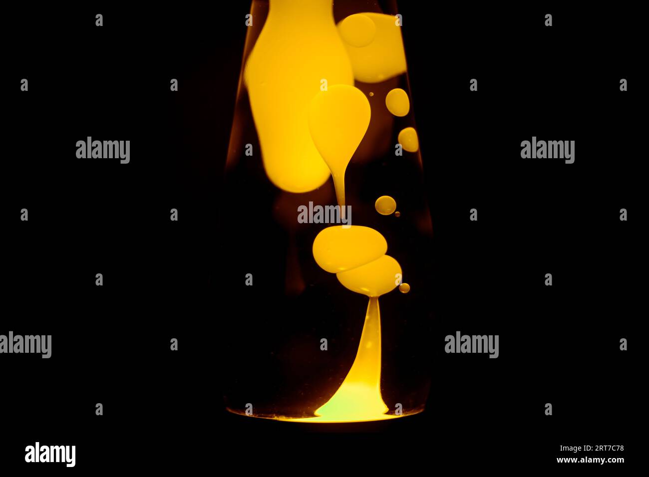 Yellow lava lamp, black background, horizontal format with copy space ...