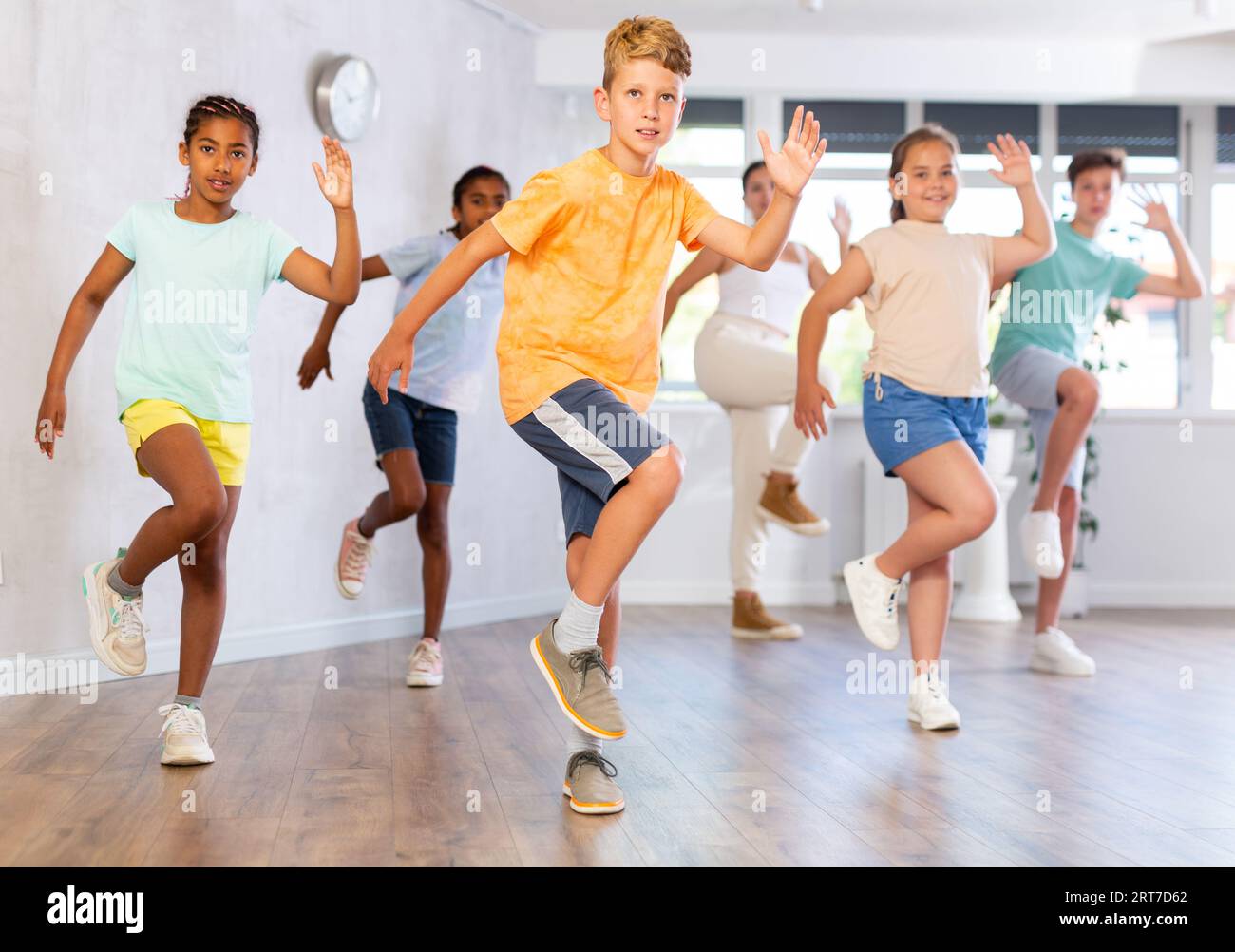 Boy dances vogue in choreographic school, friends and teacher dance in ...