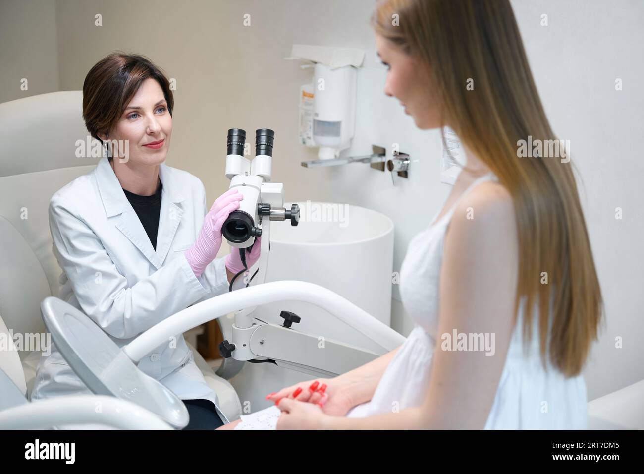 Female gynecologist uses a gynecological microscope in her work Stock ...