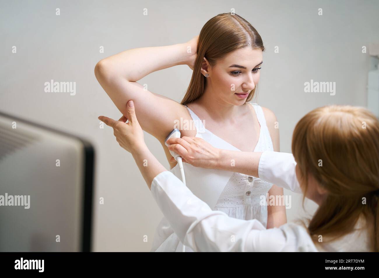 Cute young woman on procedure of ultrasound of lymph nodes Stock Photo ...
