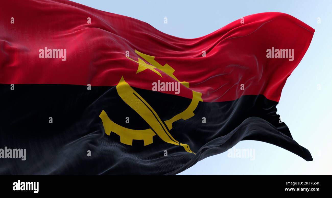 The national flag of Angola waving in the wind on a clear day. Two ...