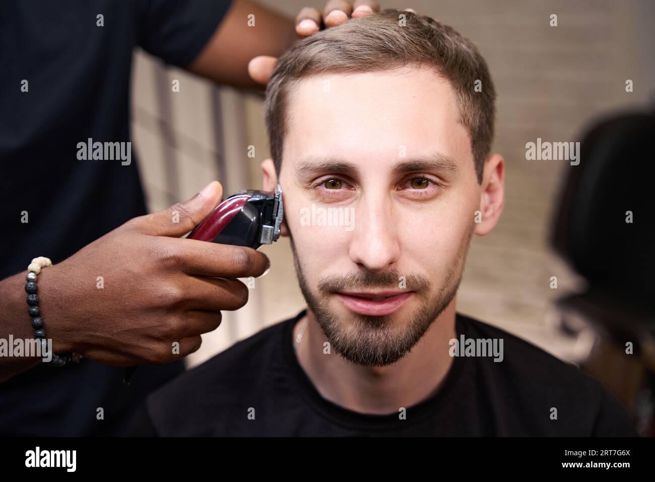Professional barber cuts clients hair hi-res stock photography and ...