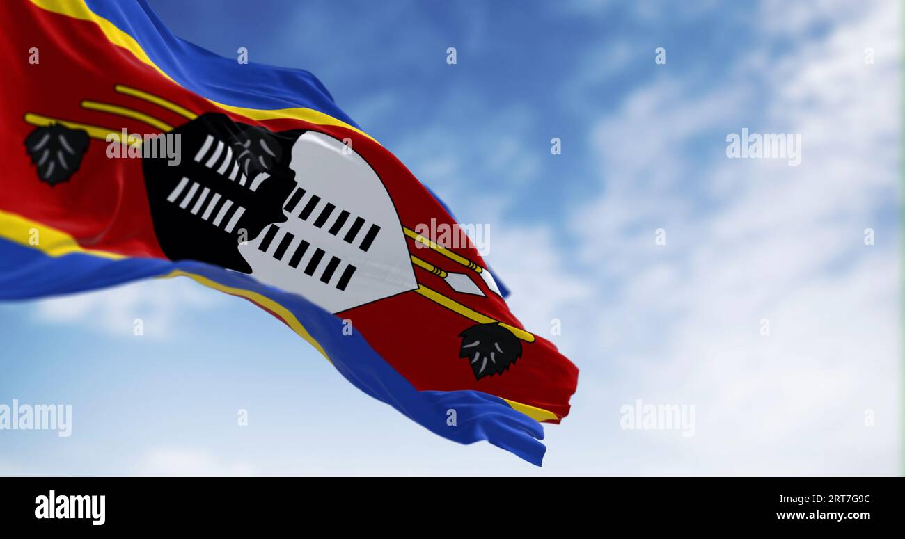 Eswatini national flag waving a clear day. Stripes of blue, yellow, red ...