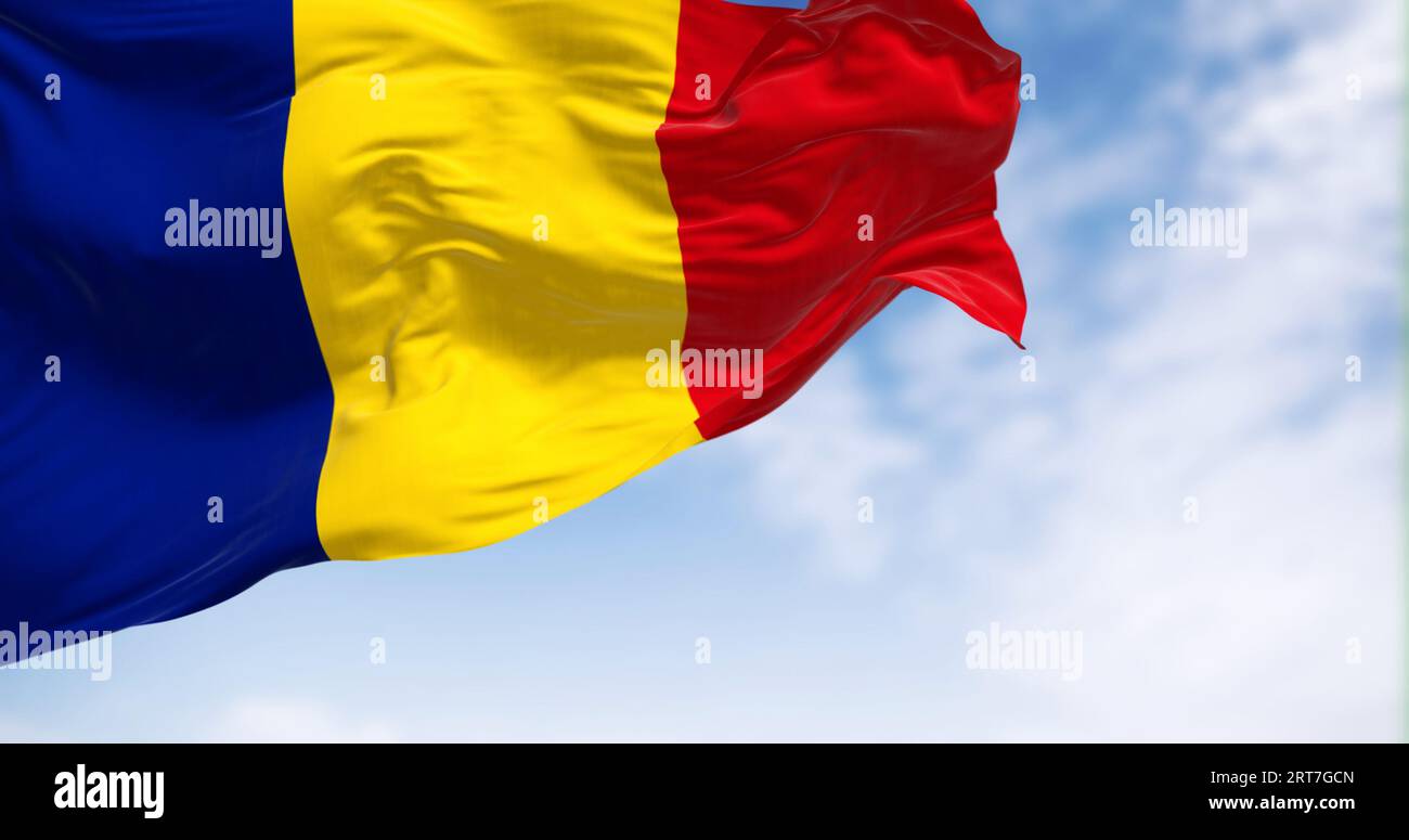 Romania national flag waving in the wind on a clear day. Three vertical ...
