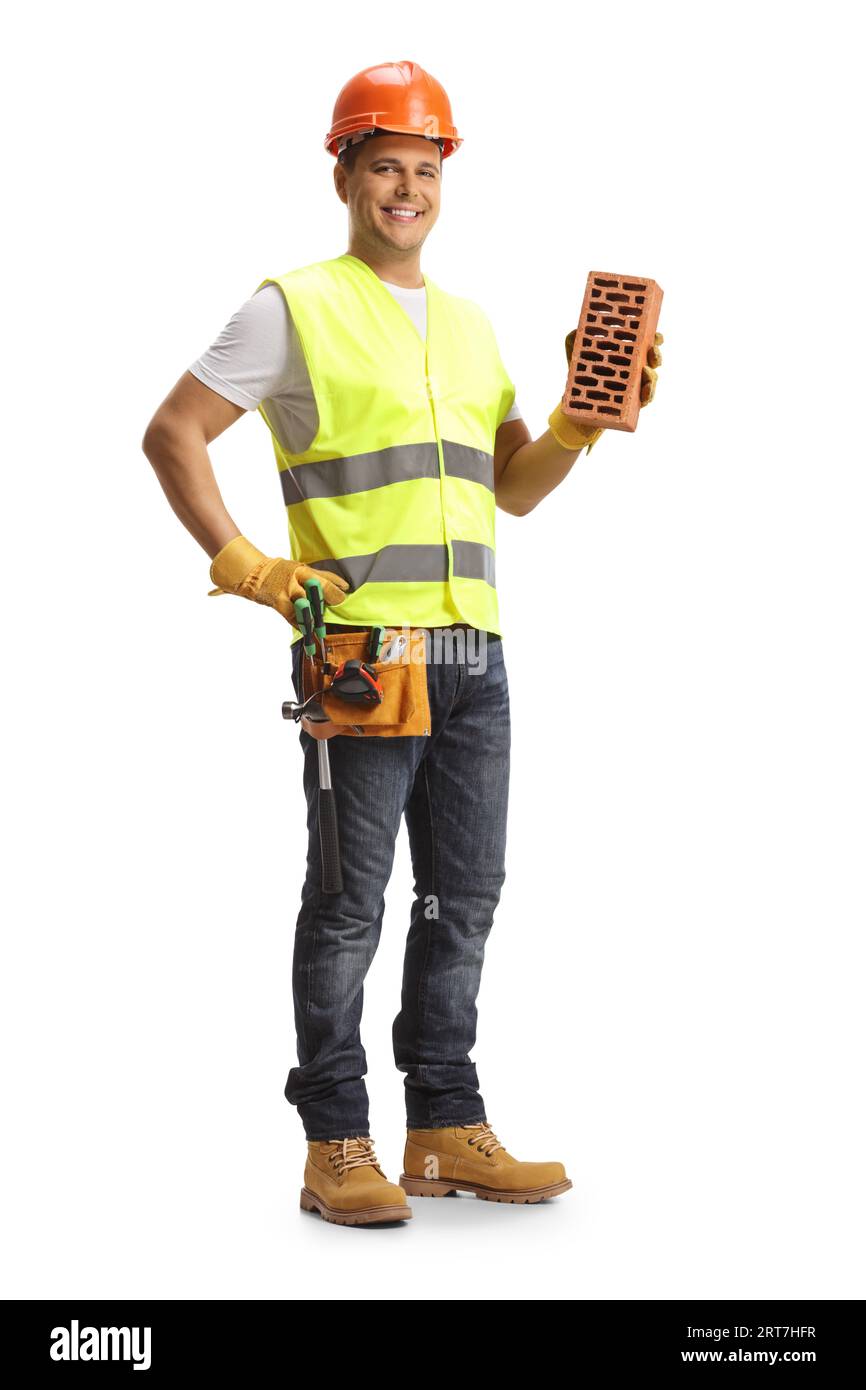 Smiling construction worker holding a brick isolated on white background Stock Photo - Alamy