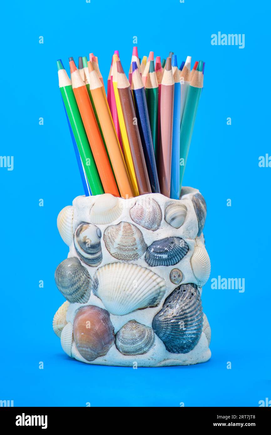 Pencil holder created with salt dough and sea shells on a blue ...