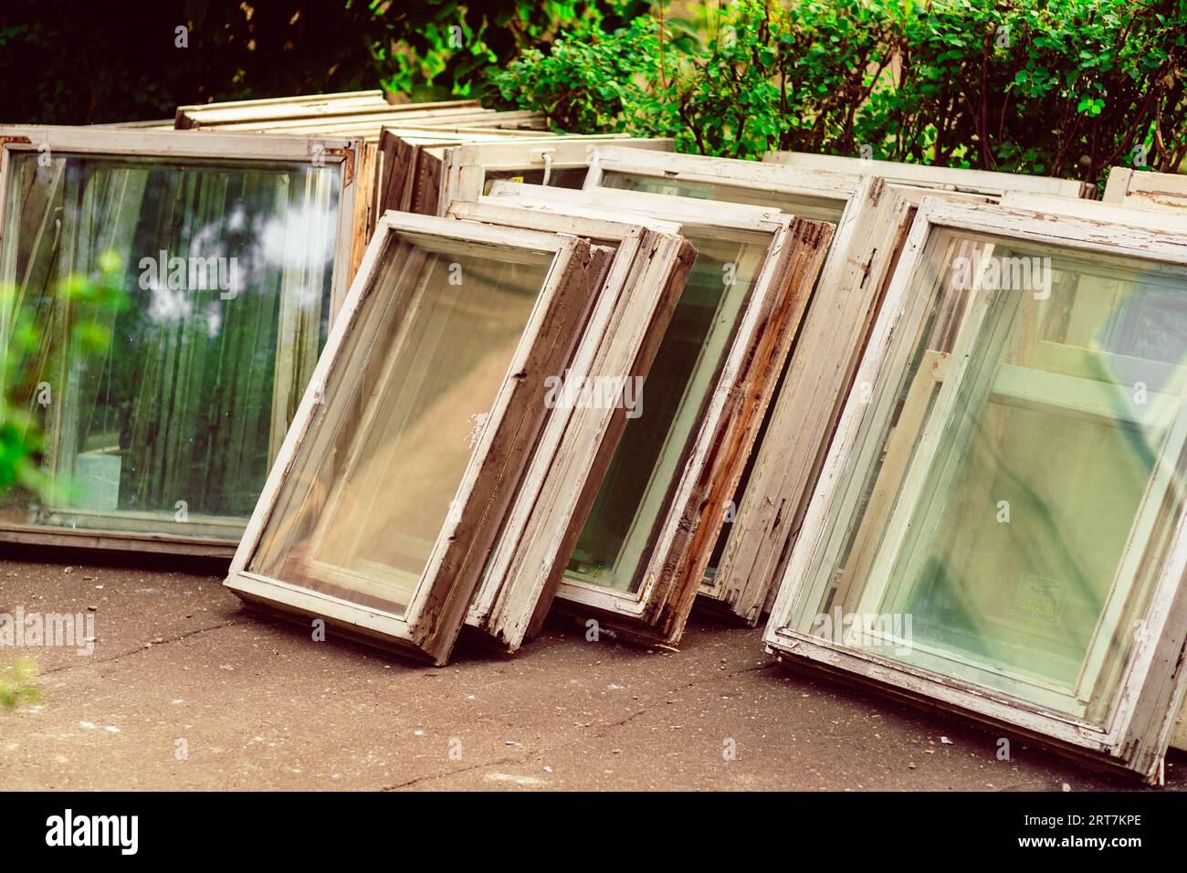 Bunch of old wooden windows frames on the street. Replacement of ...
