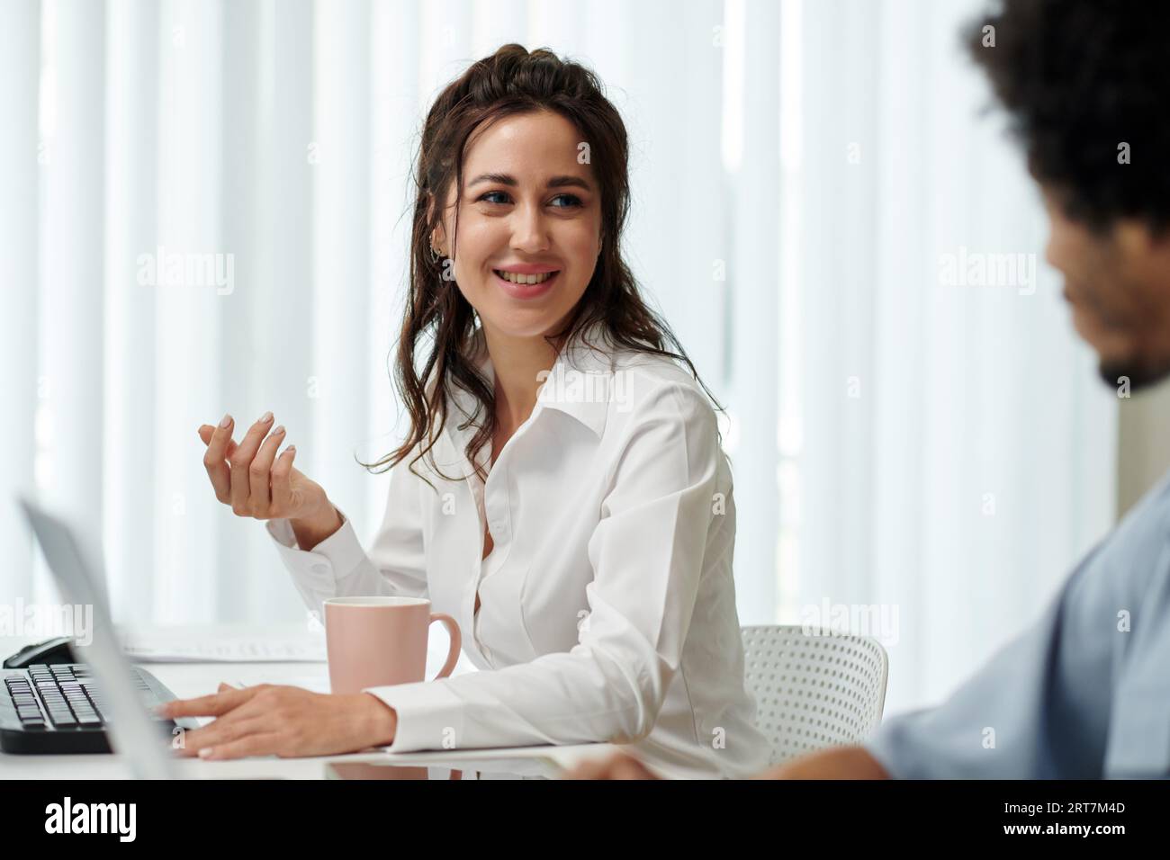 Smiling young product manager discussing bugs and features with front ...