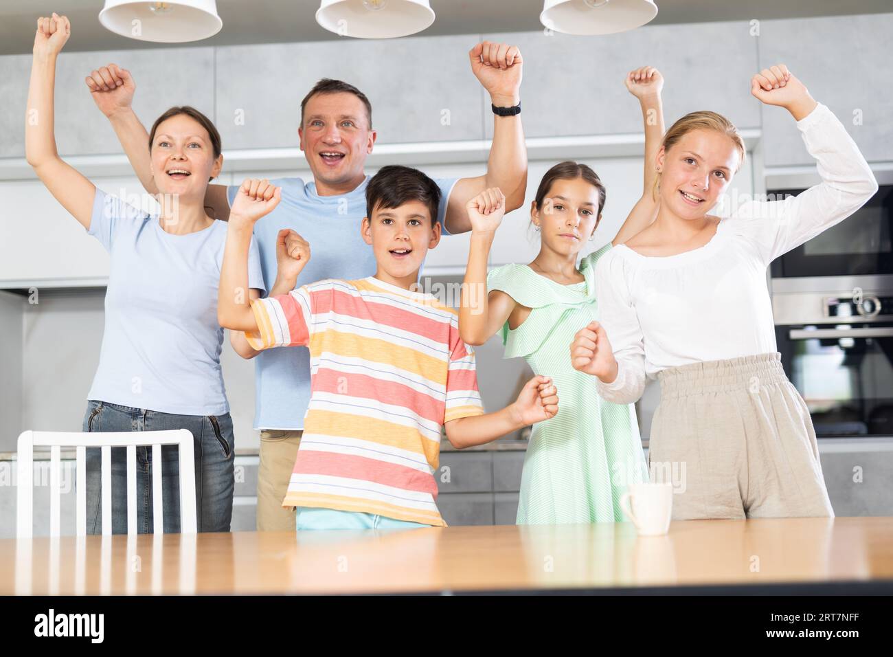 Portrait of happy family, children and parents scream with joy and hold ...