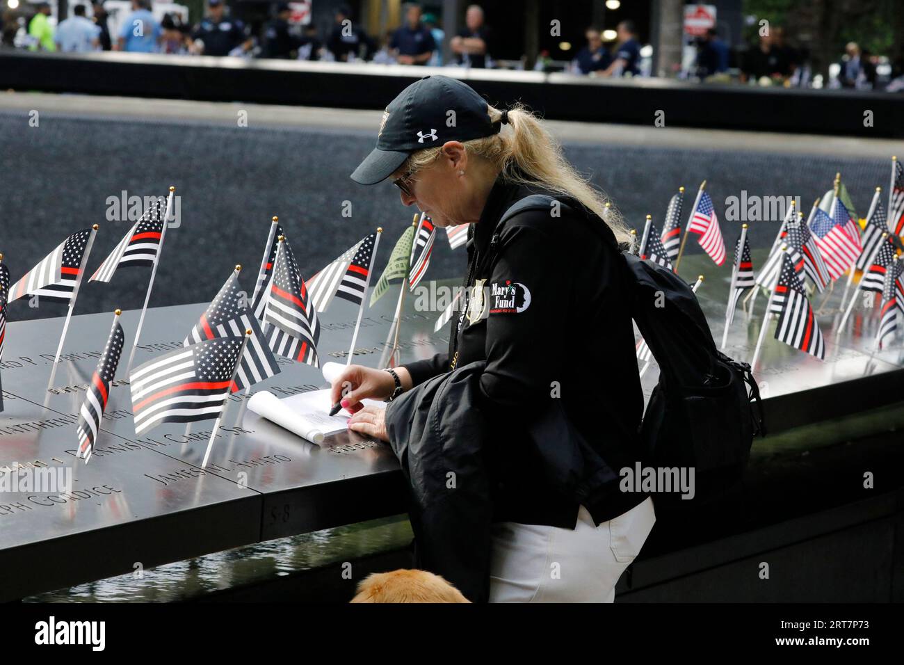 New York, United States. 11th Sep, 2023. A first responder etches a ...