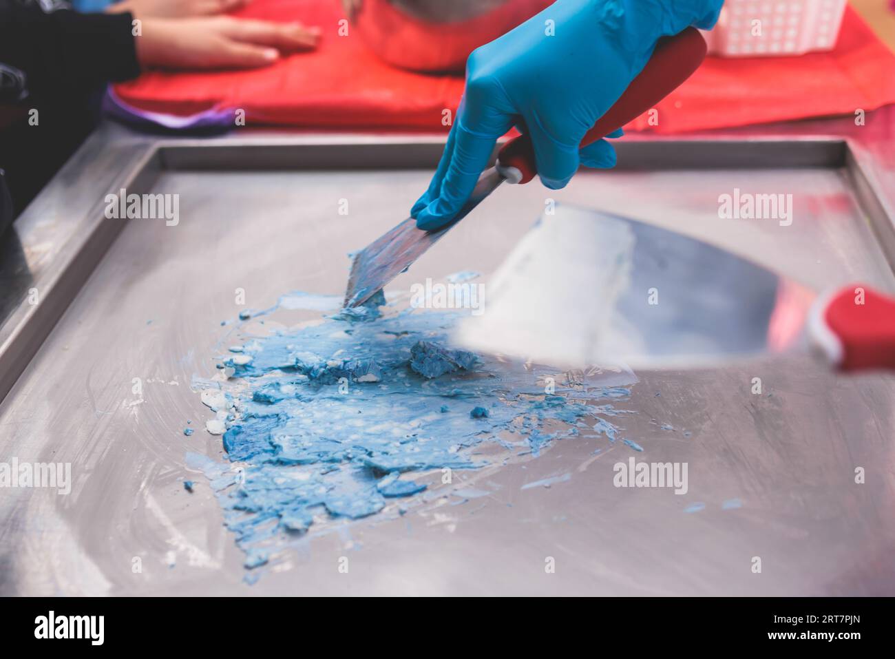 Rolled thai ice cream preparation, process of cooking coloured fried ...