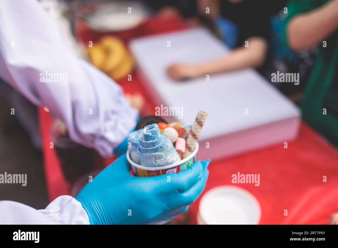 Rolled thai ice cream preparation, process of cooking coloured fried ...