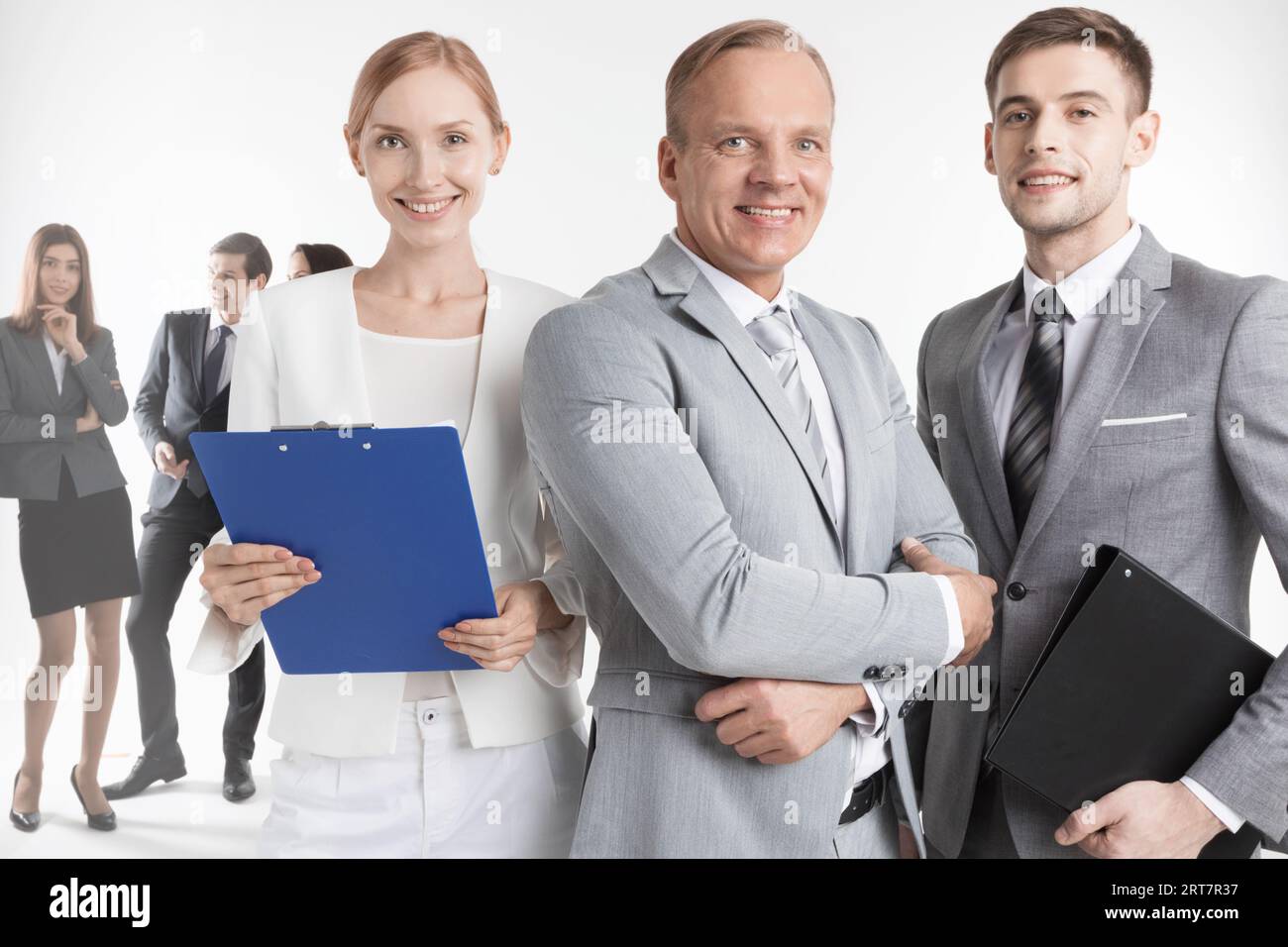 Smiling business leaders and their team isolated on white background ...