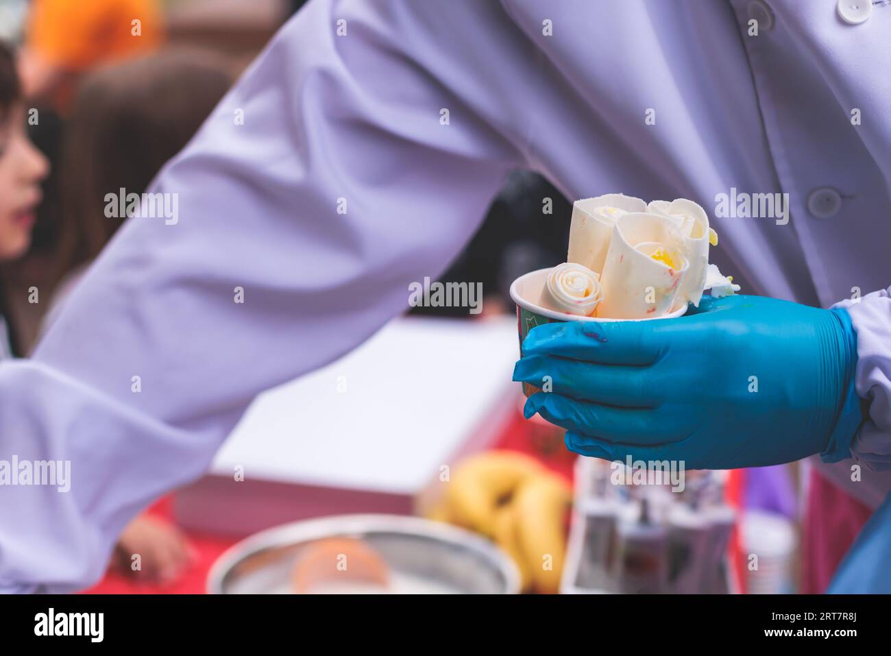 Rolled thai ice cream preparation, process of cooking coloured fried ...
