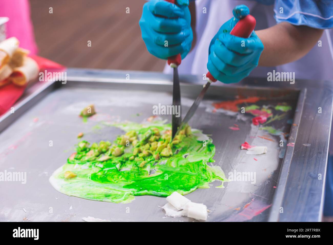Rolled thai ice cream preparation, process of cooking coloured fried ...
