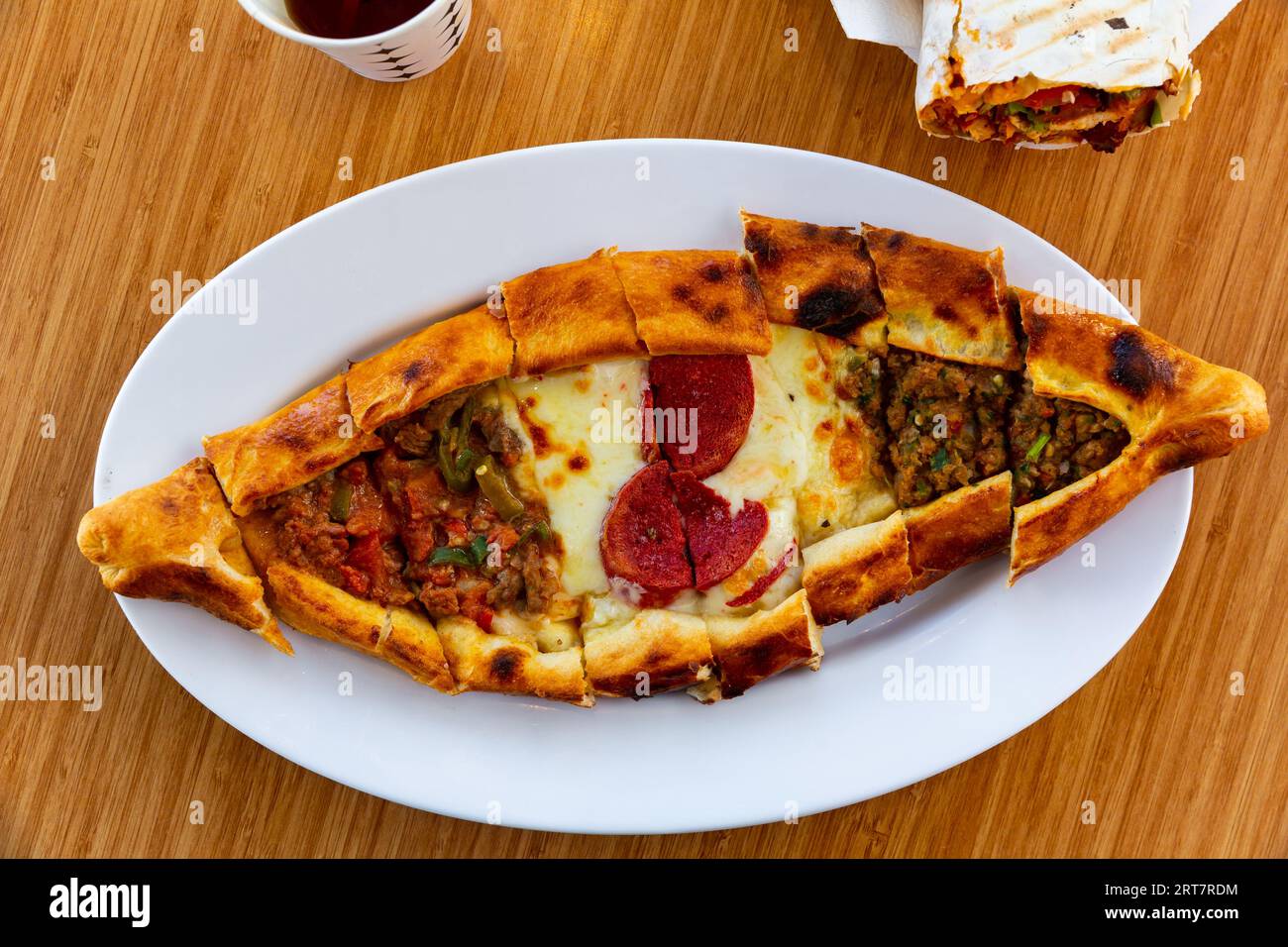 Pide, Turkish flat bread with mixed filling Stock Photo - Alamy
