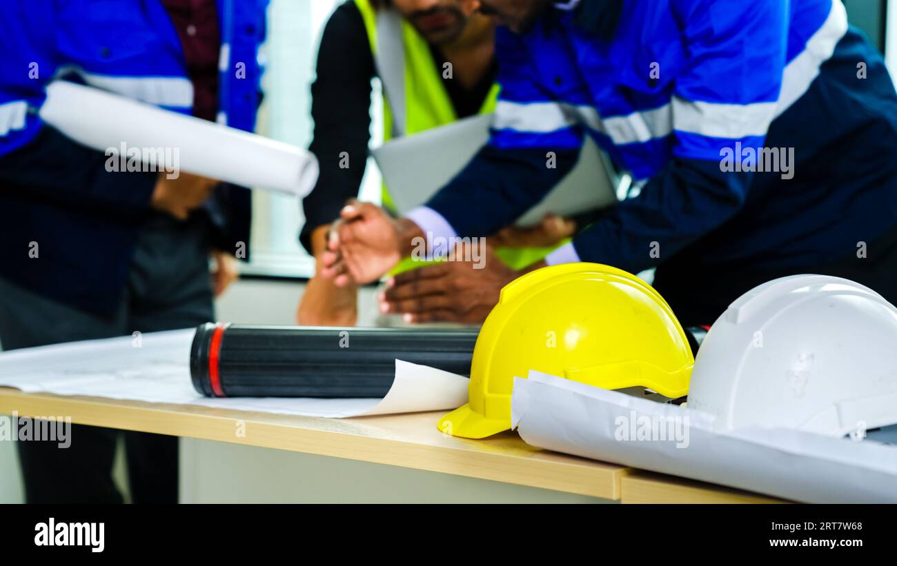 Construction engineers team using blueprint of project plan ...