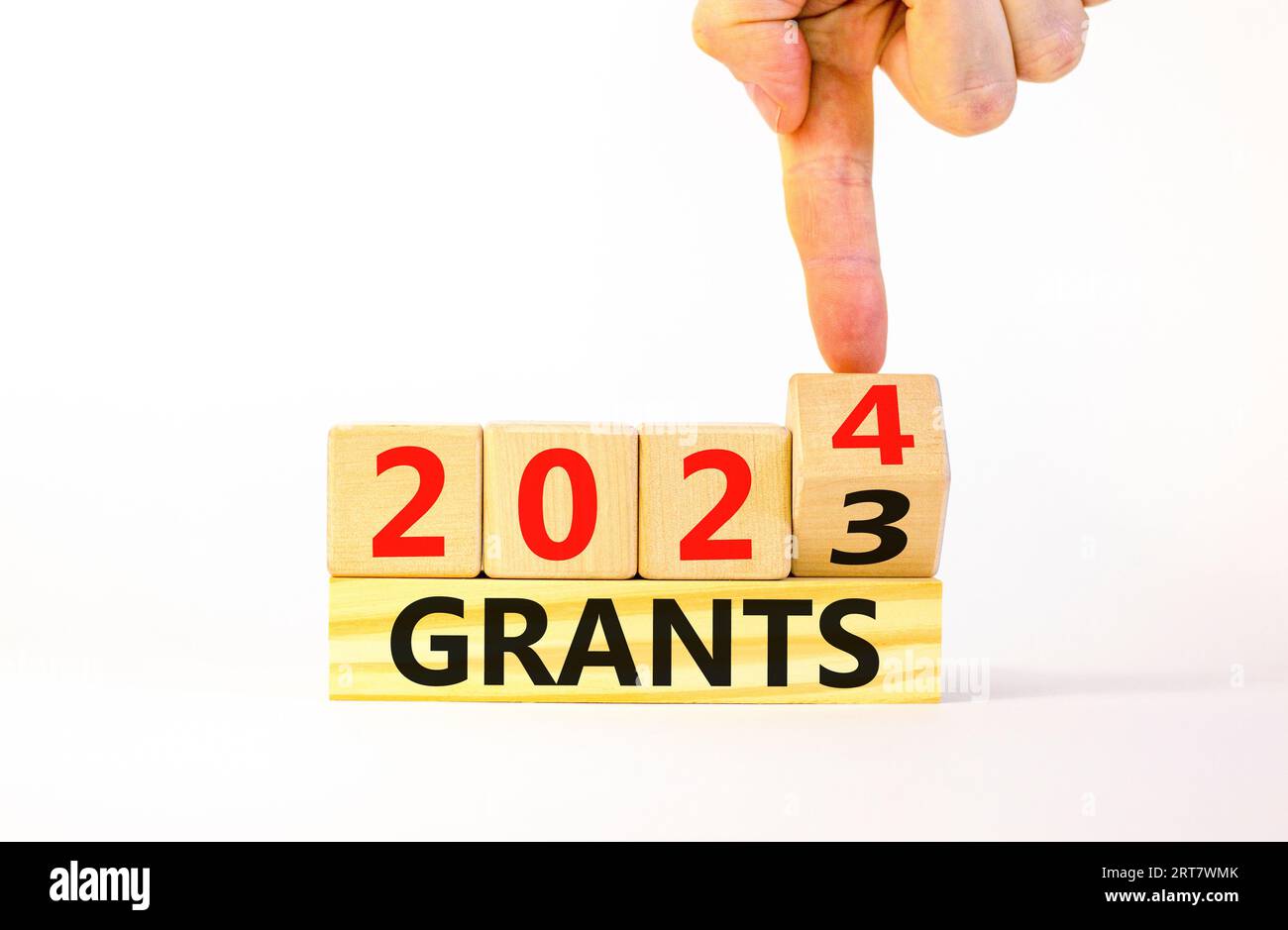 Planning 2024 grants new year symbol. Businessman turns a wooden cube ...