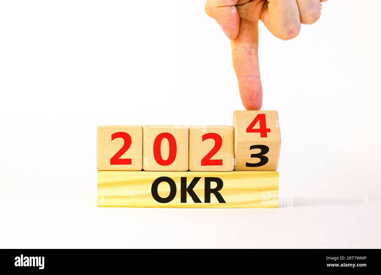 OKR, objectives and key results symbol. Businessman turns cubes with words OKR 2023 and OKR 2024 ...