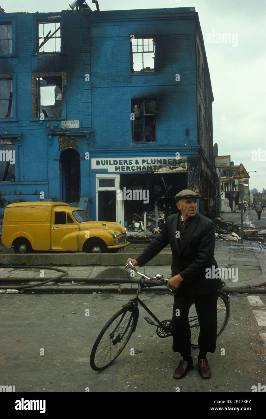 Brixton Riots 1980s UK. The day after the riot a local man on his push ...