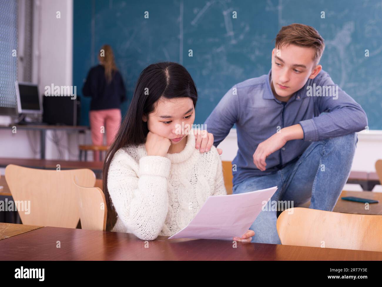 Friend comforting Chinese girl student Stock Photo - Alamy