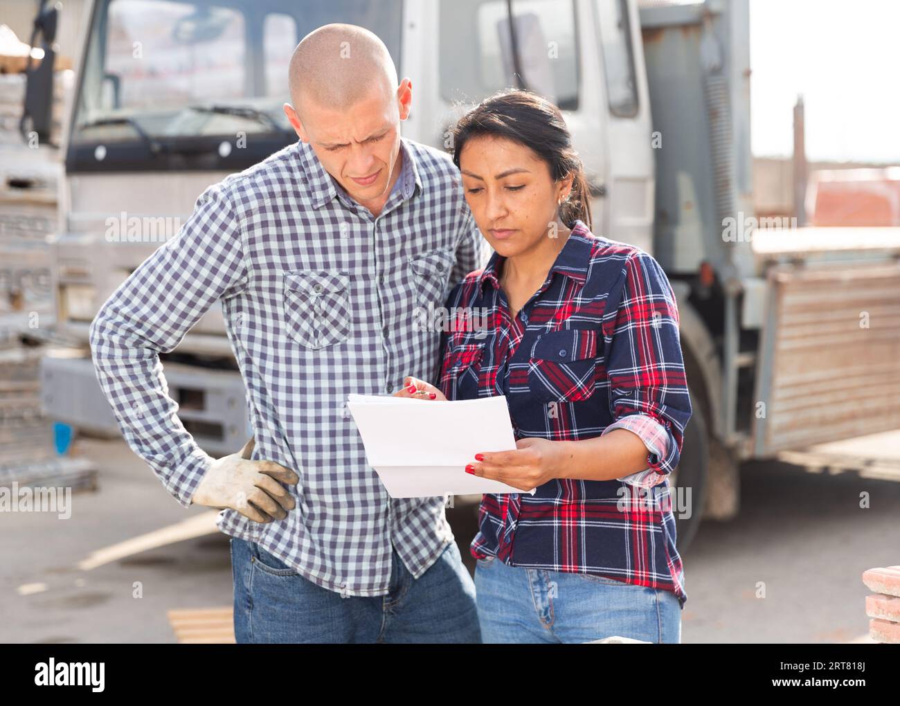 Woman manager giving instructions to a worker at the construction site ...