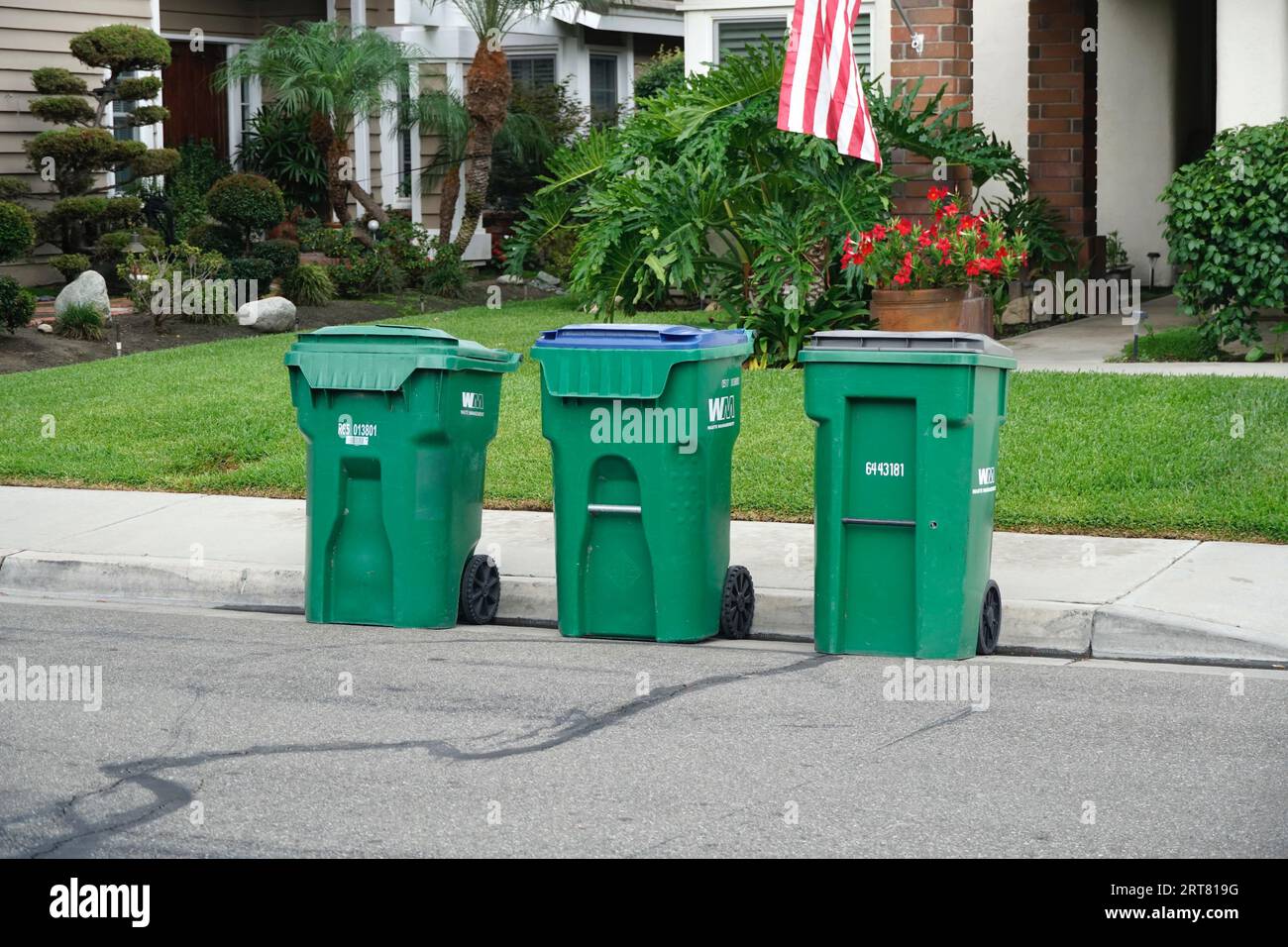 Three garbage cans on the street Stock Photo - Alamy