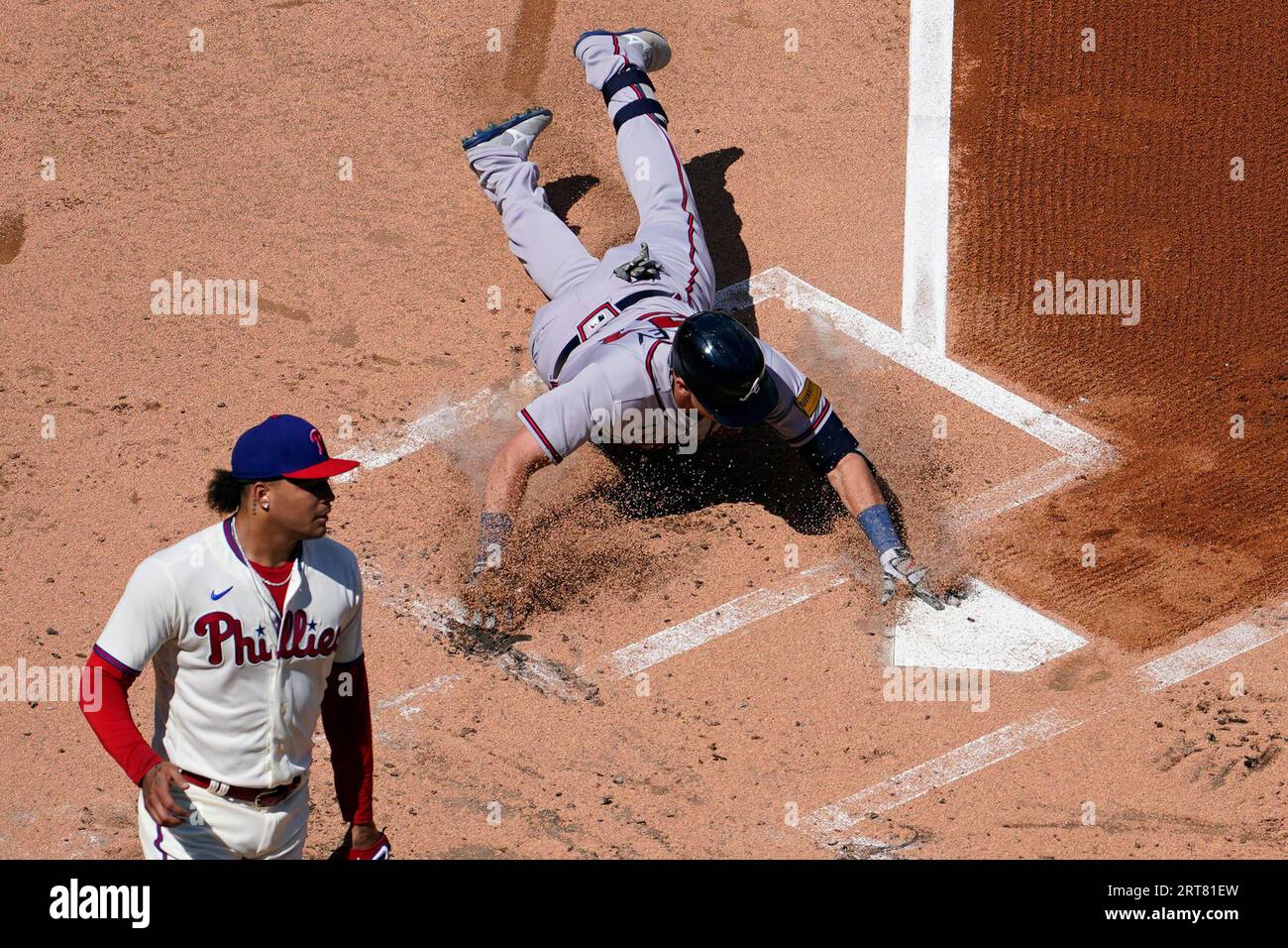 Atlanta Braves' Austin Riley, right, scores on a fielding error after ...