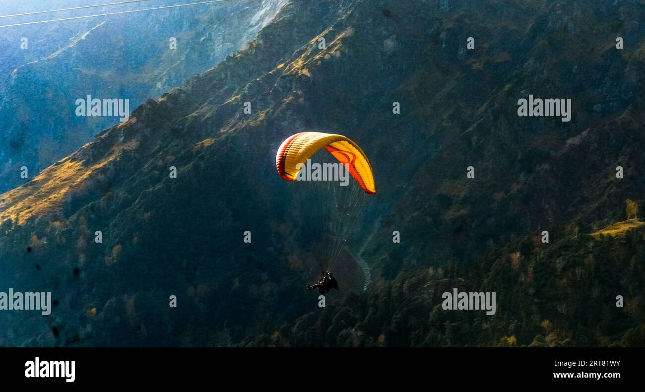 A parachute flying against mountain background Stock Photo - Alamy