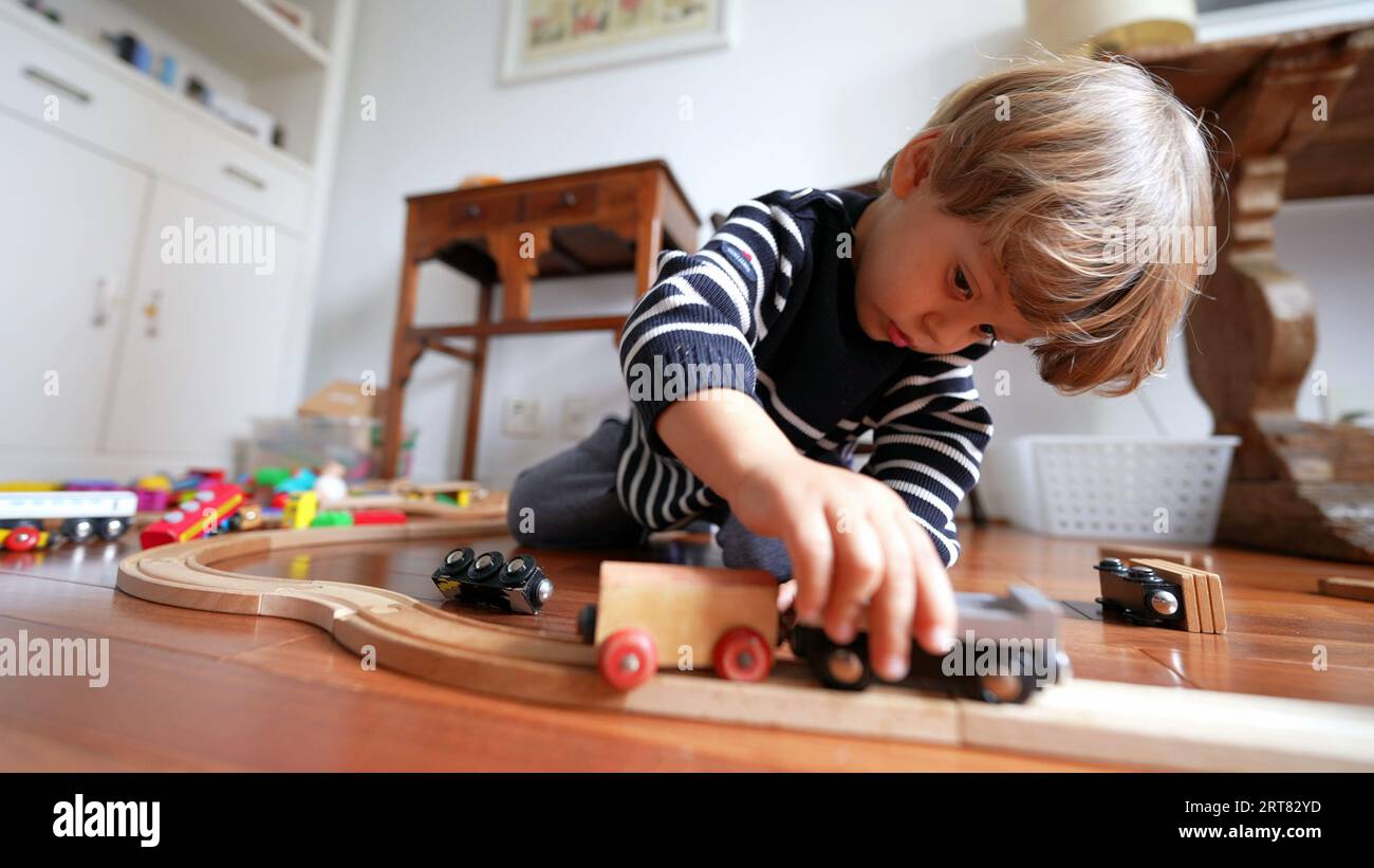 Boy Playing with Vintage Train Set at Home, Close-up of Kid's Hand with ...
