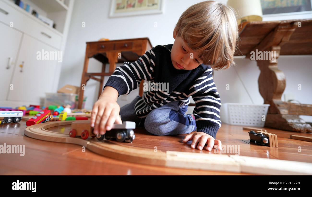 Boy Playing with Vintage Train Set at Home, Close-up of Kid's Hand with ...