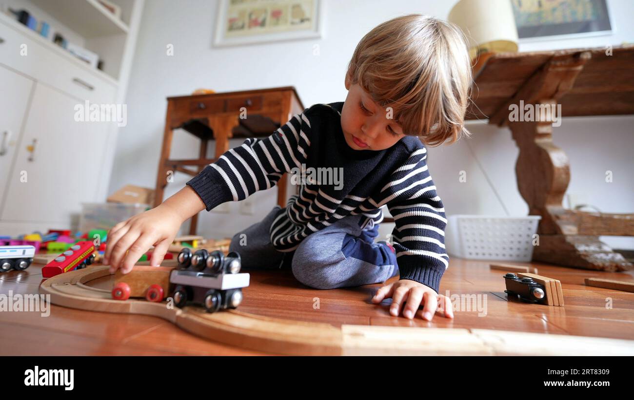 Boy Playing with Vintage Train Set at Home, Close-up of Kid's Hand with ...