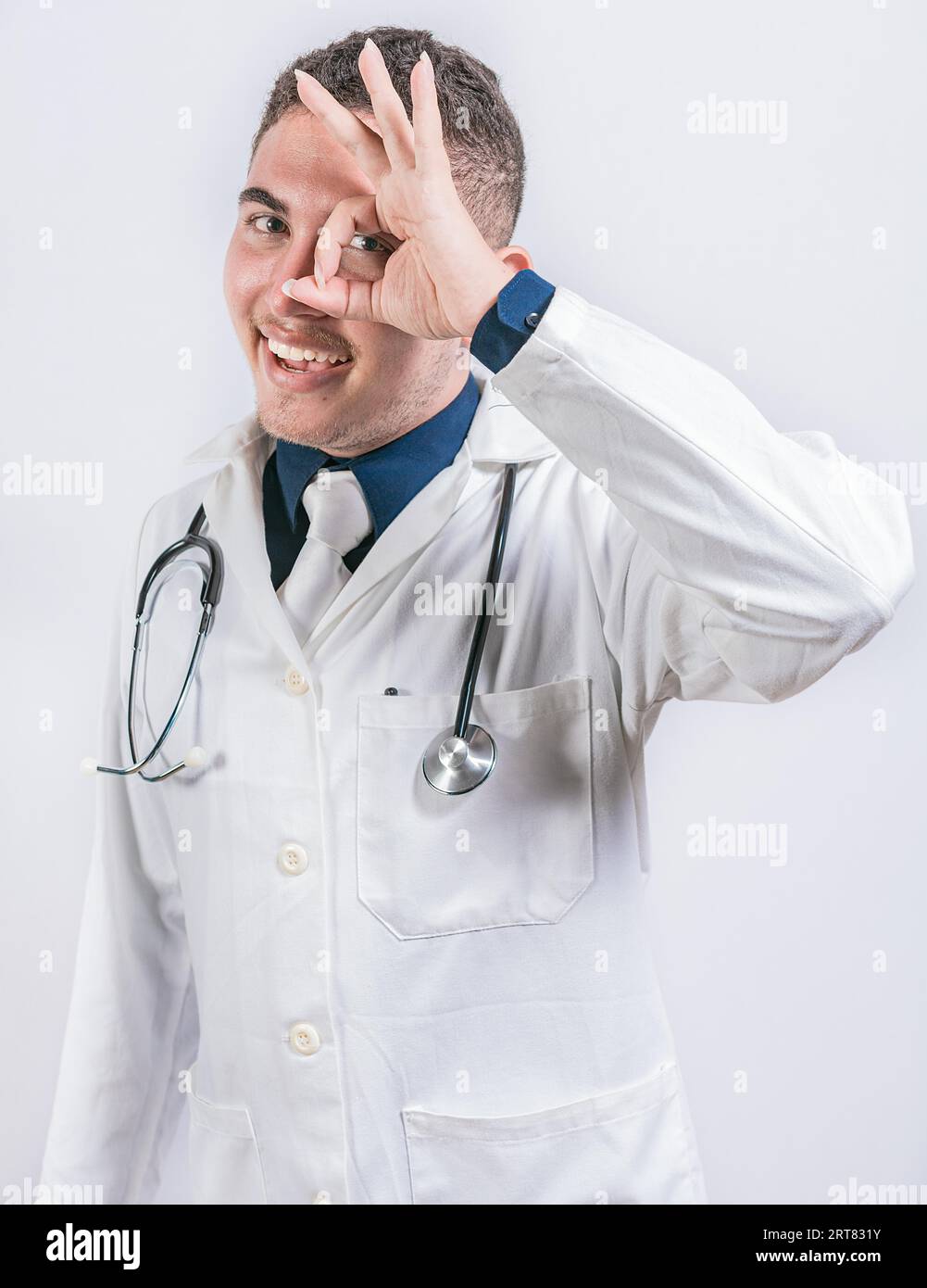 Cheerful doctor gesturing approval isolated. Latin doctor approving on ...