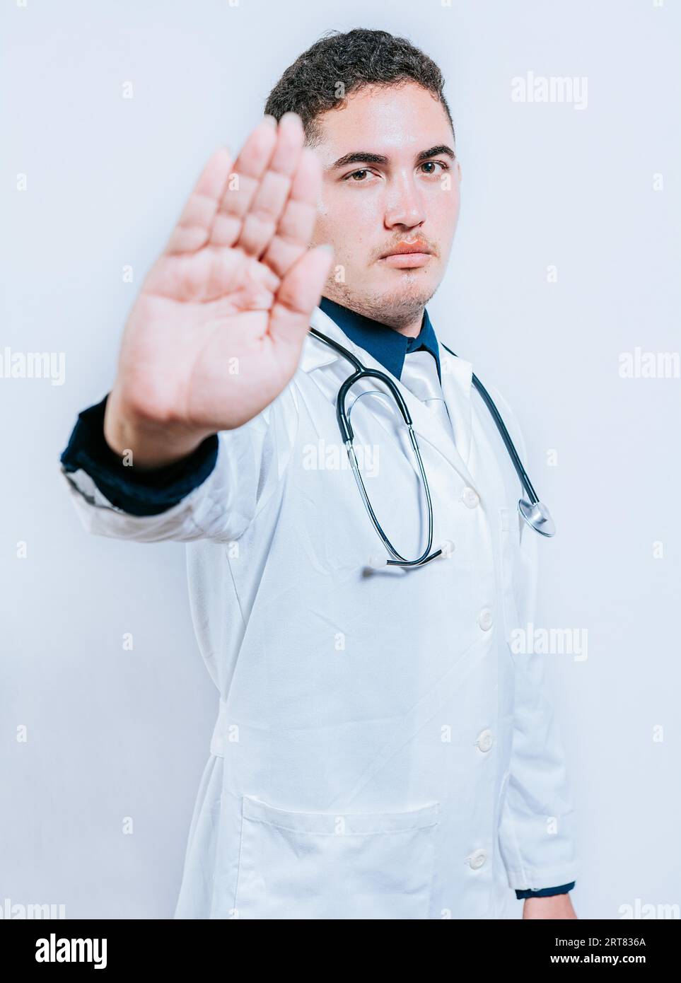 Handsome doctor making stop gesture isolated, Young doctor making stop ... Handsome doctor making stop gesture isolated, Young doctor making stop ...