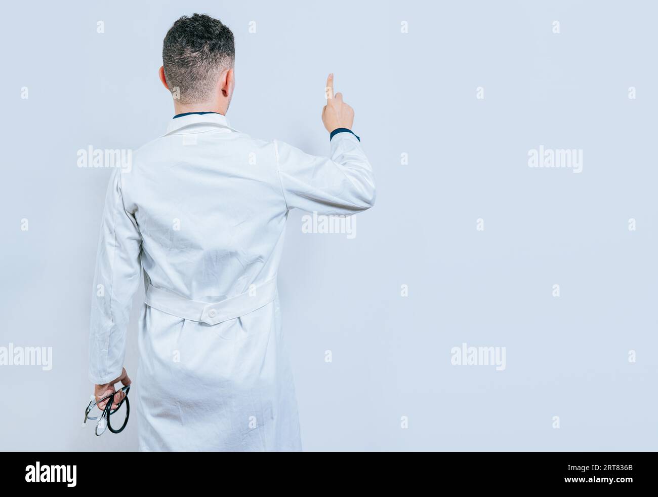 Rear view of doctor pointing isolated. Doctor posing from back pointing ...