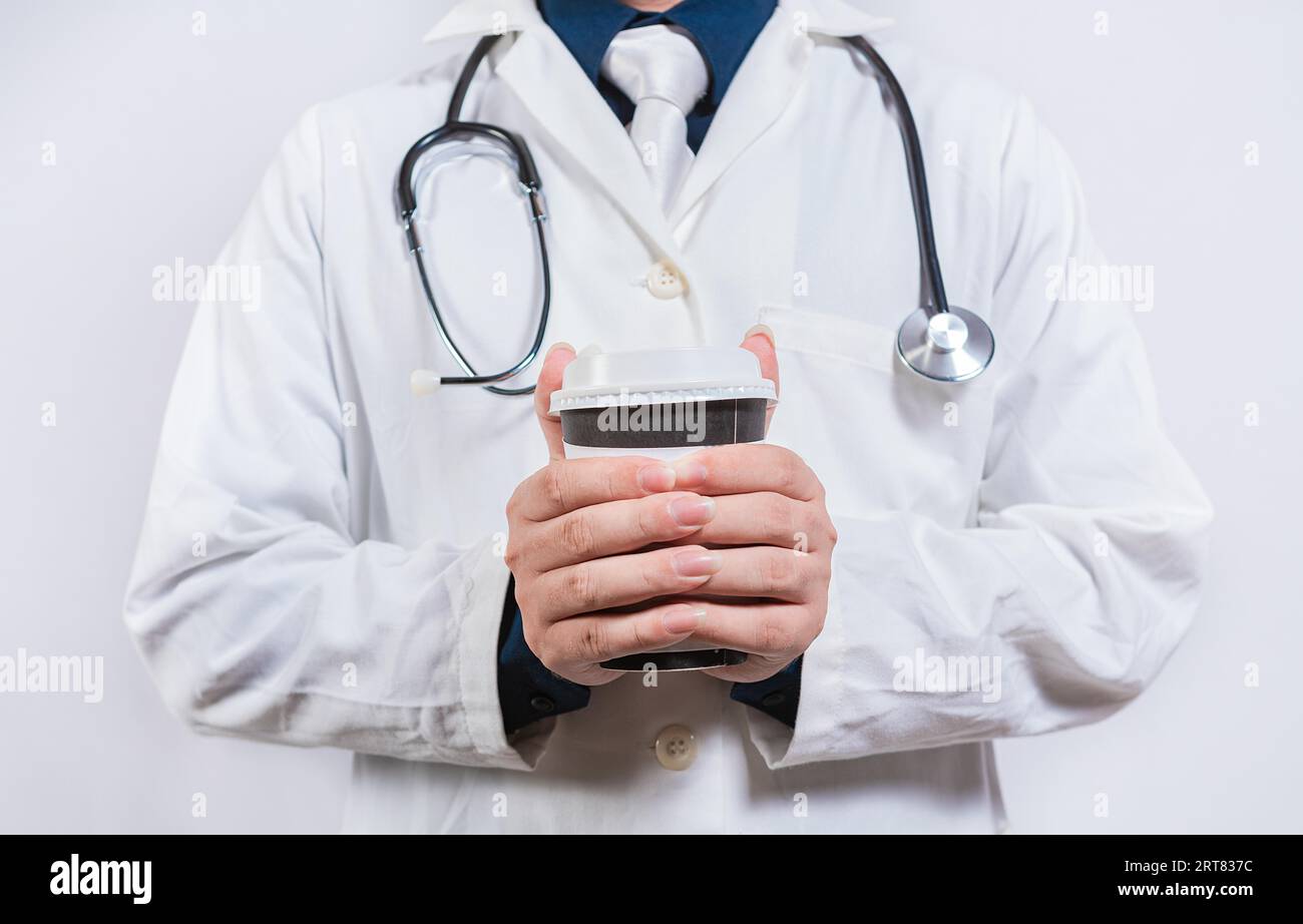 Hands of doctor holding takeaway coffee on isolated background. Doctor ...