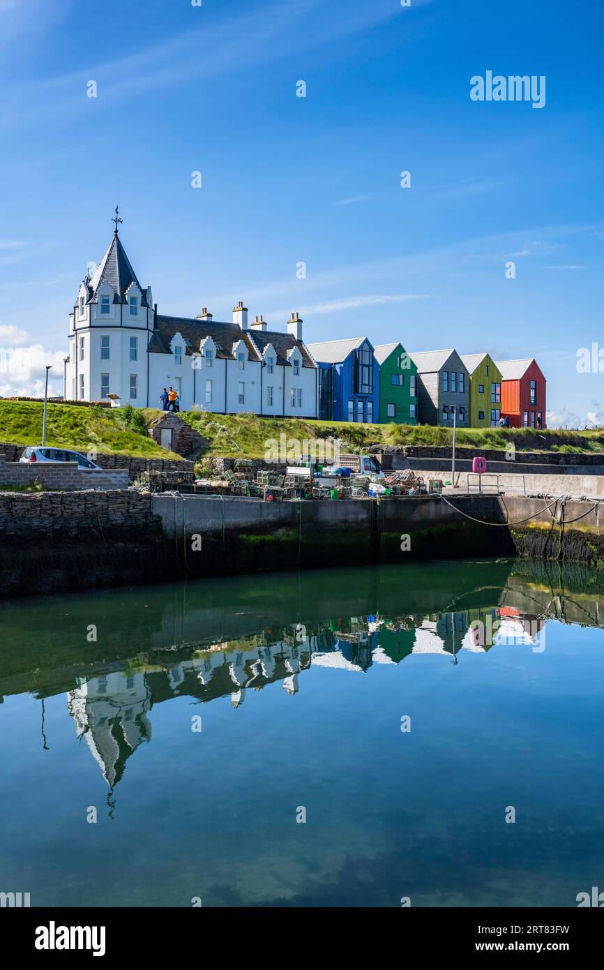 Holiday homes reflected in the ferry harbour of John o' Groats, County ...