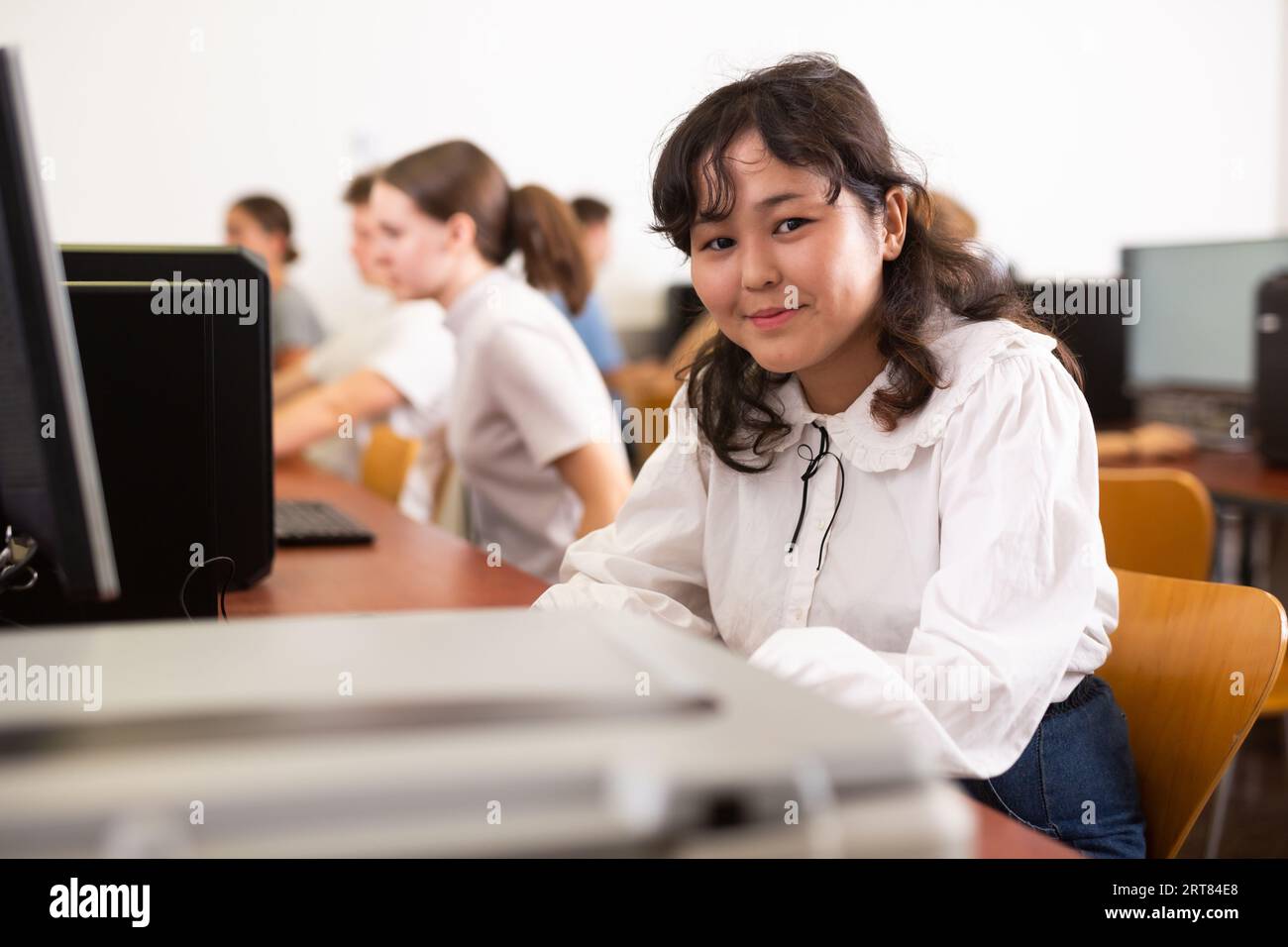 Concentrated Asian female student using PC and studying computer ...