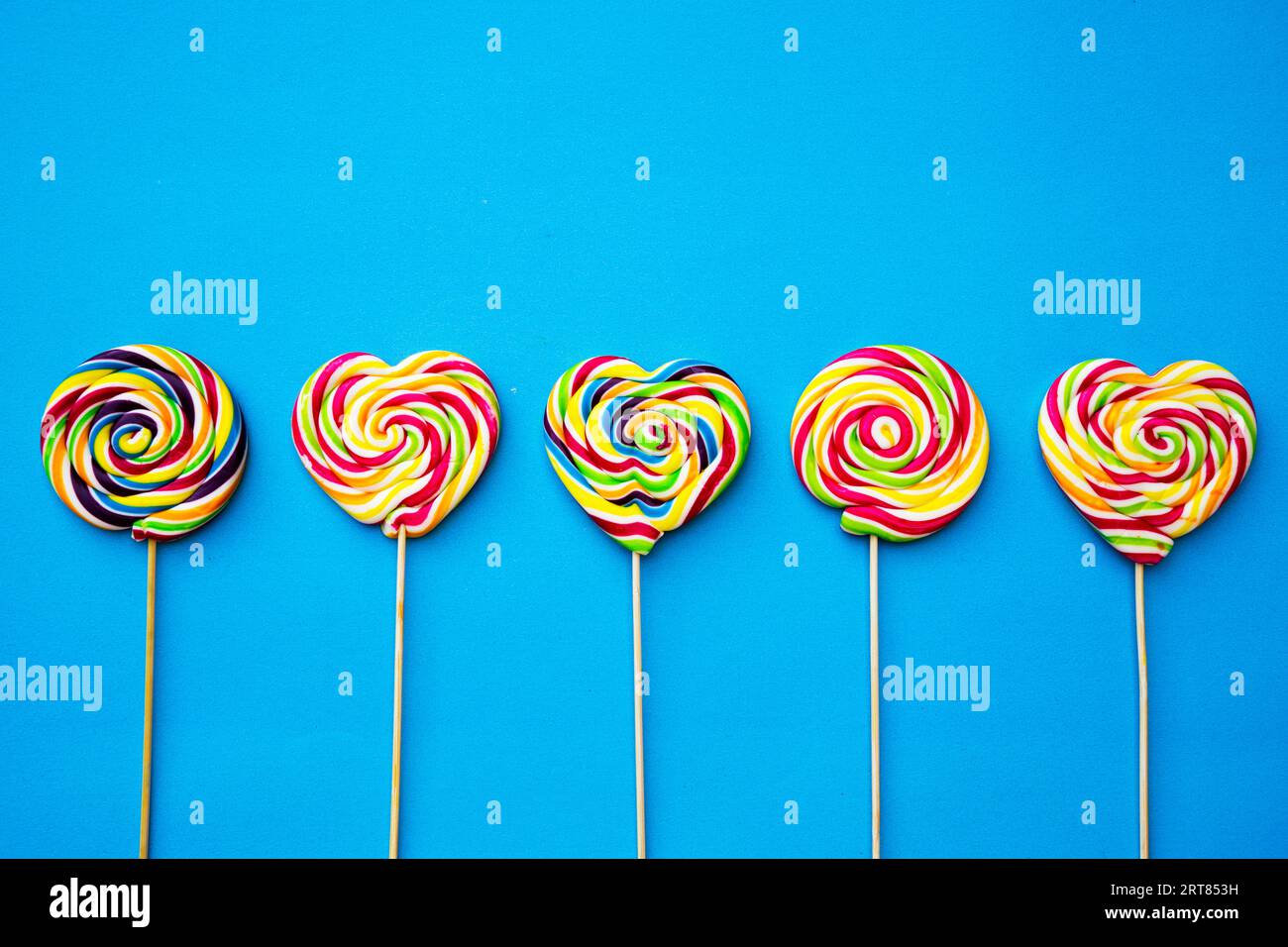 colored, different sweets, lollipops on a blue background. Copy space ...