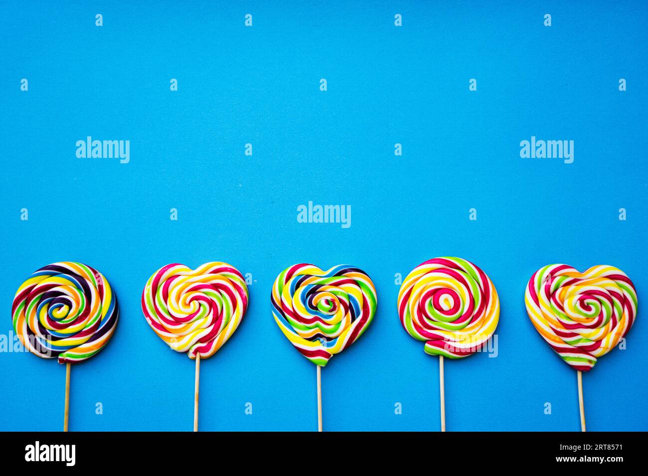 colored, different sweets, lollipops on a blue background. Copy space ...