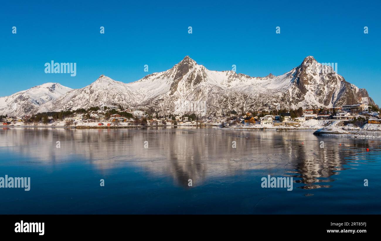 Beautiful winter landscape with lake and steep mountains near Svolvaer ...